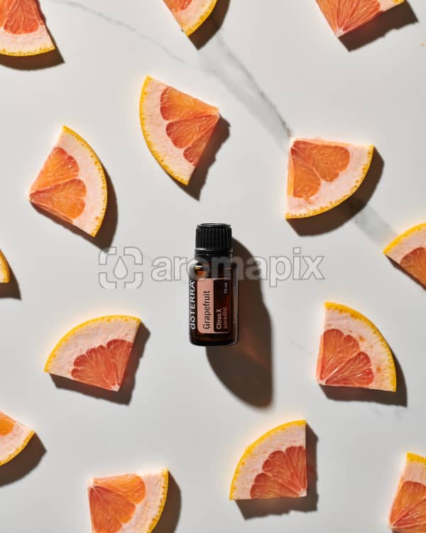 Doterra Grapefruit Essential Oil And Grapefruit Slices Stock Photo ...